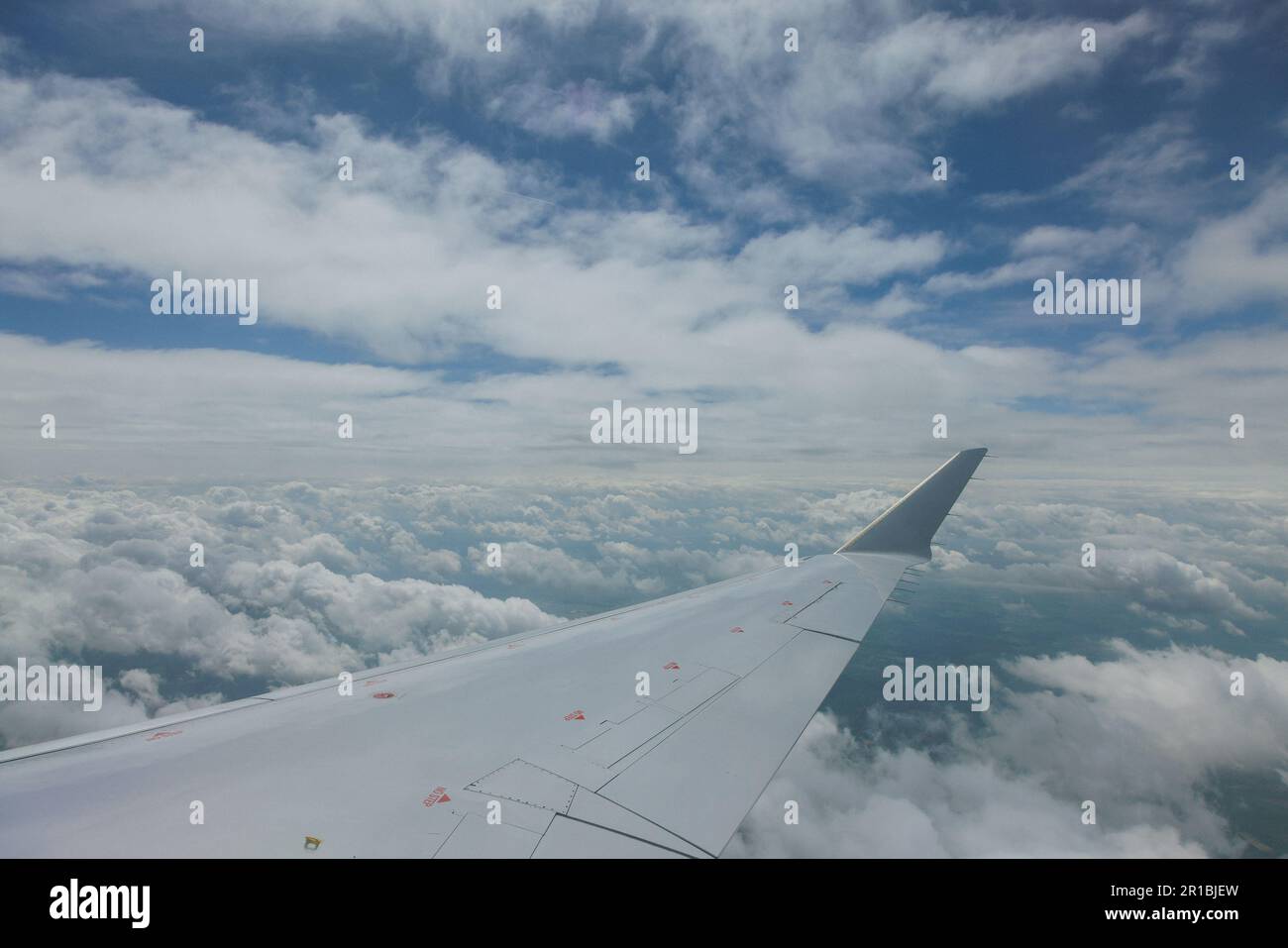 Window view during flight in wing of an aircraft with gorgeous blue sky ...