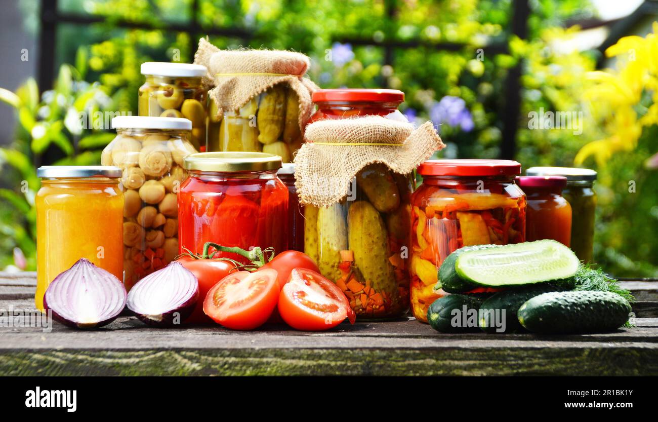 Jars of pickled vegetables in the garden. Marinated food Stock Photo ...