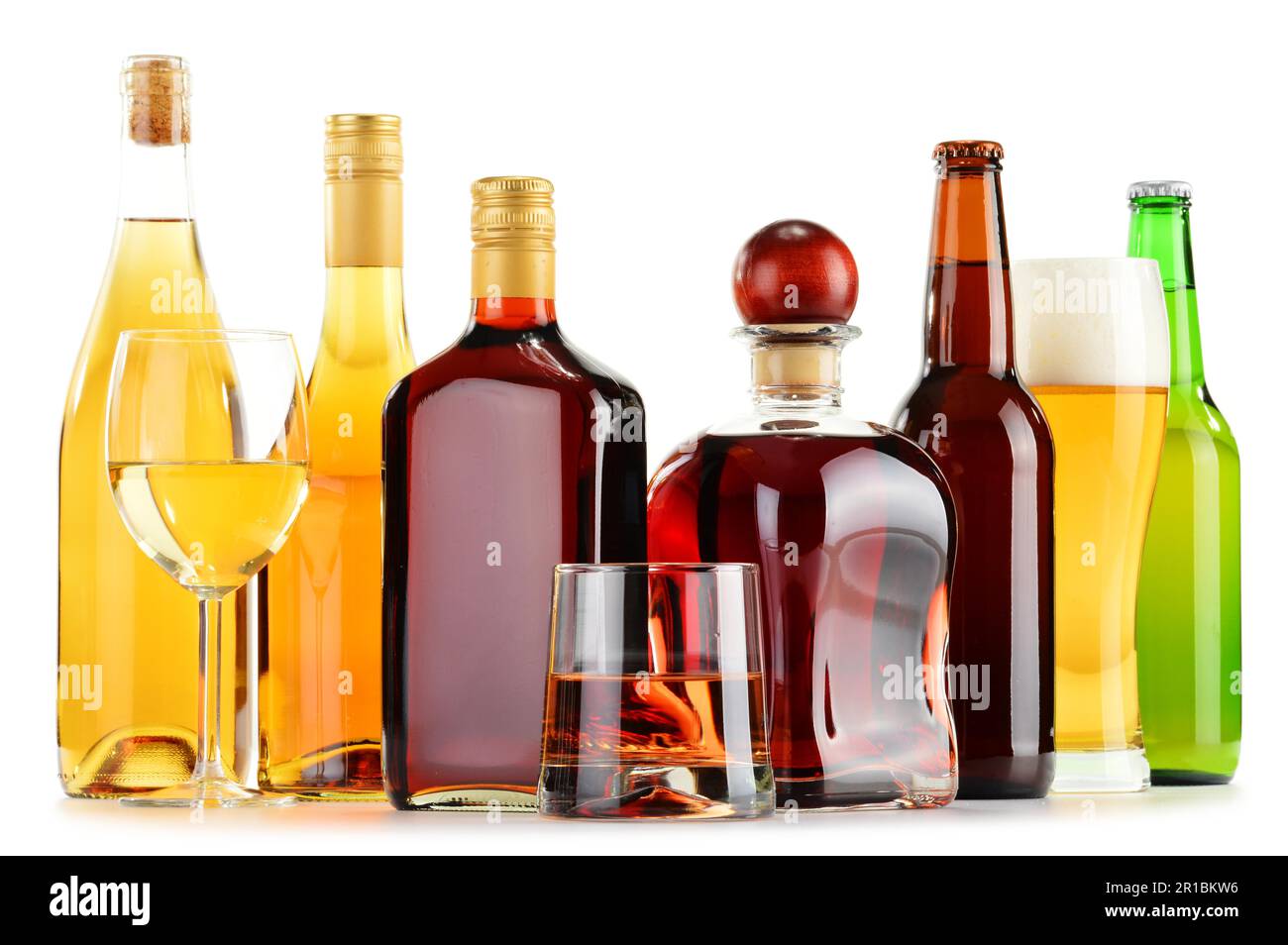 Bottles and glasses of assorted alcoholic beverages isolated on white ...