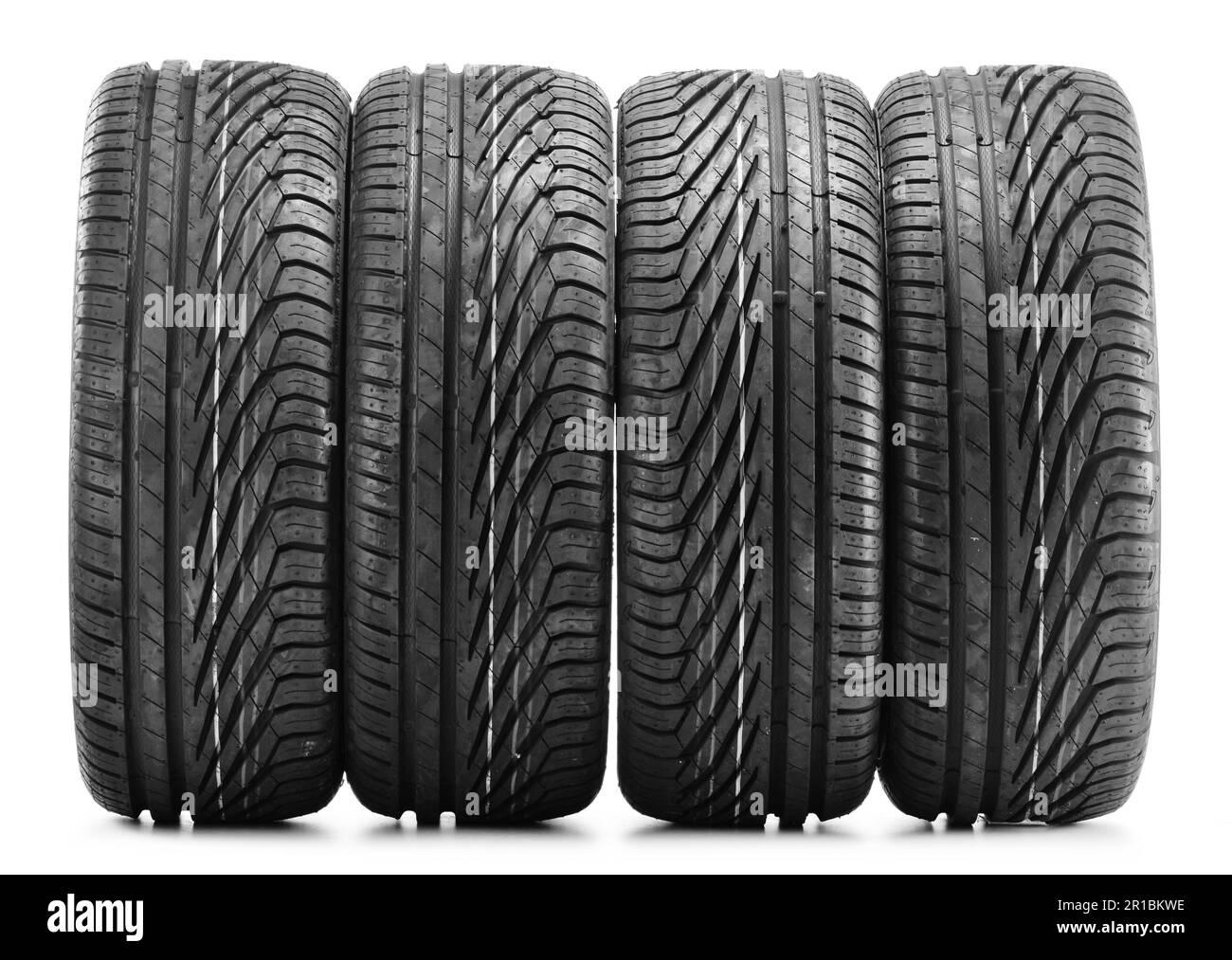 Four new black tires isolated on white background Stock Photo - Alamy
