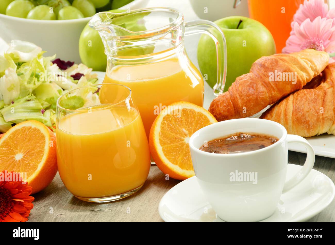 Breakfast consisting of fruits, orange juice, coffee, honey, bread and ...