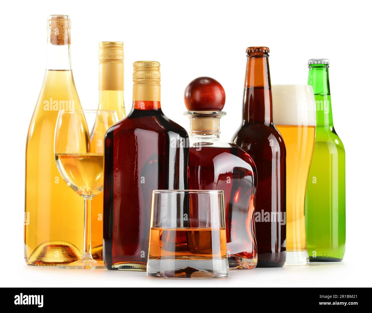 Bottles and glasses of assorted alcoholic beverages isolated on white ...