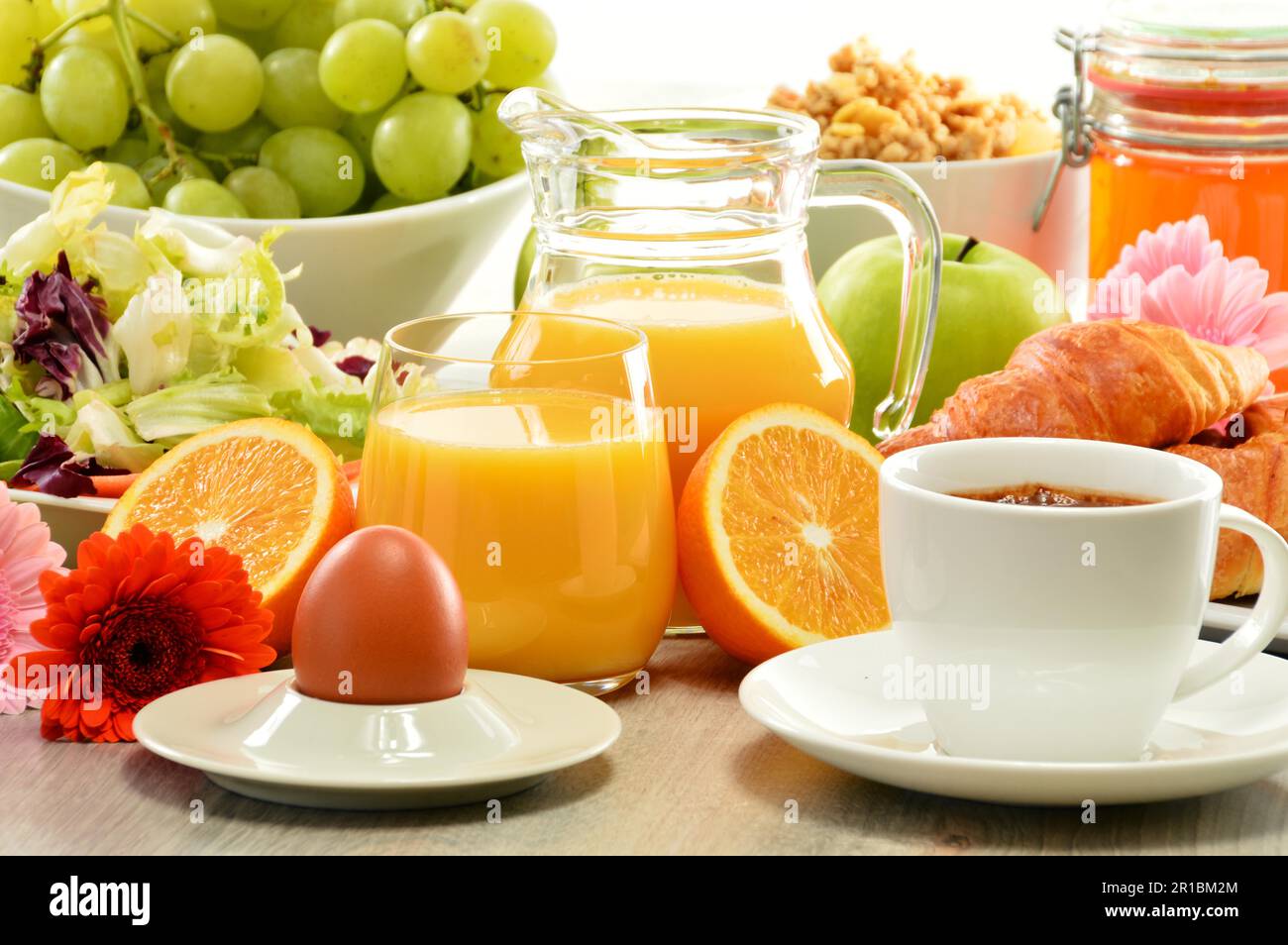 Breakfast consisting of fruits, orange juice, coffee, honey, bread and ...