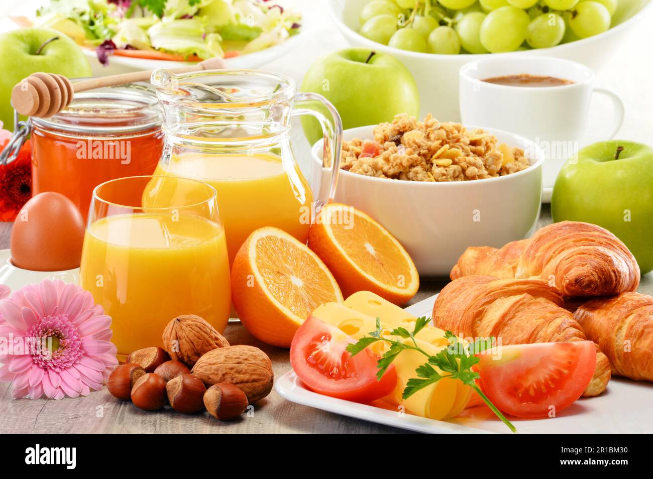 Breakfast consisting of fruits, orange juice, coffee, honey, bread and ...