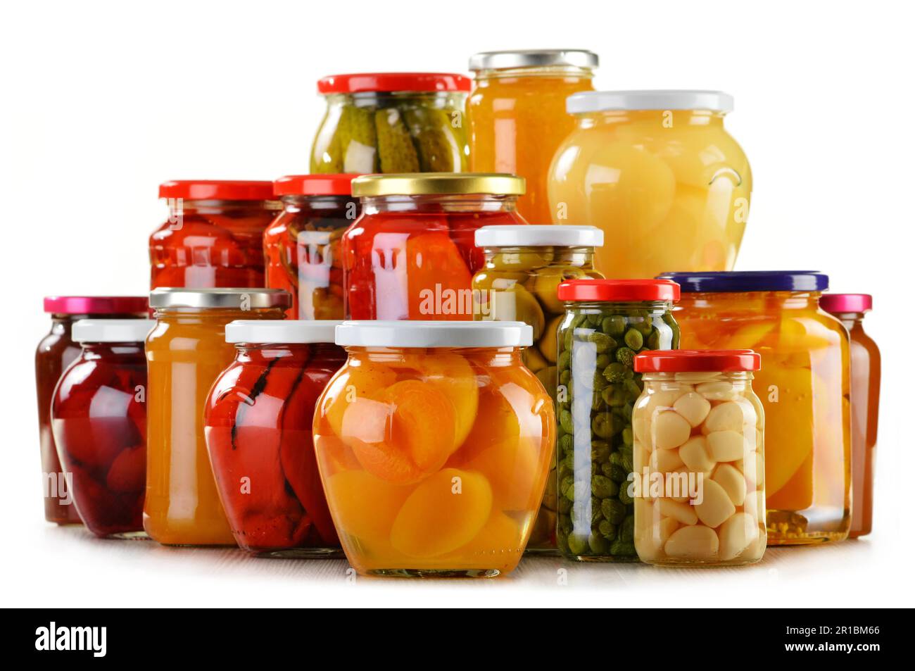 Jars with fruity compotes jams and pickled vegetables isolated on white ...