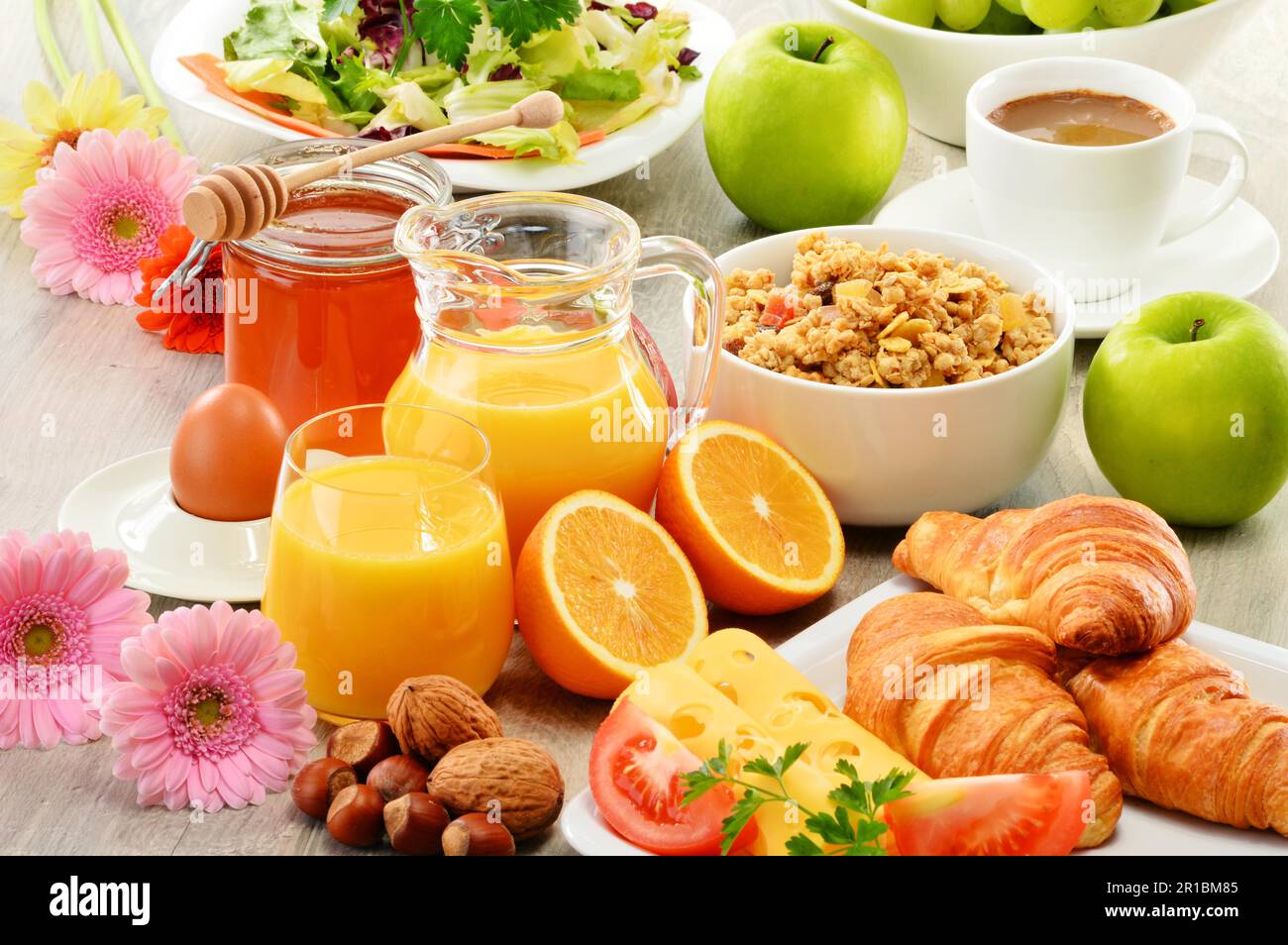 Breakfast consisting of fruits, orange juice, coffee, honey, bread and ...