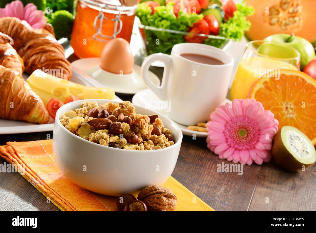 Breakfast consisting of fruits, orange juice, coffee, honey, bread and ...