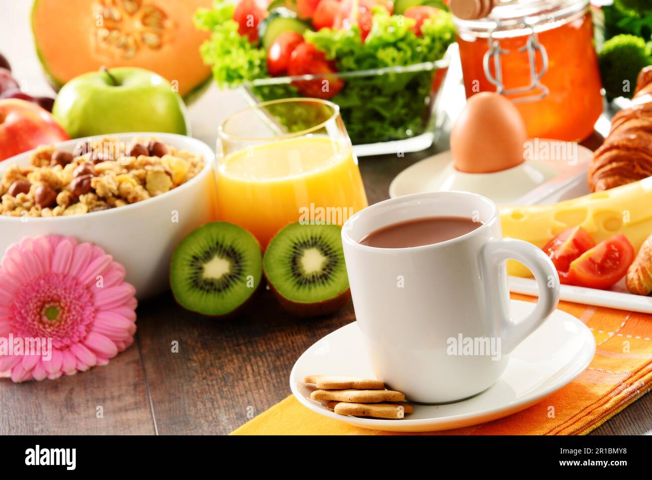 Breakfast consisting of fruits, orange juice, coffee, honey, bread and ...
