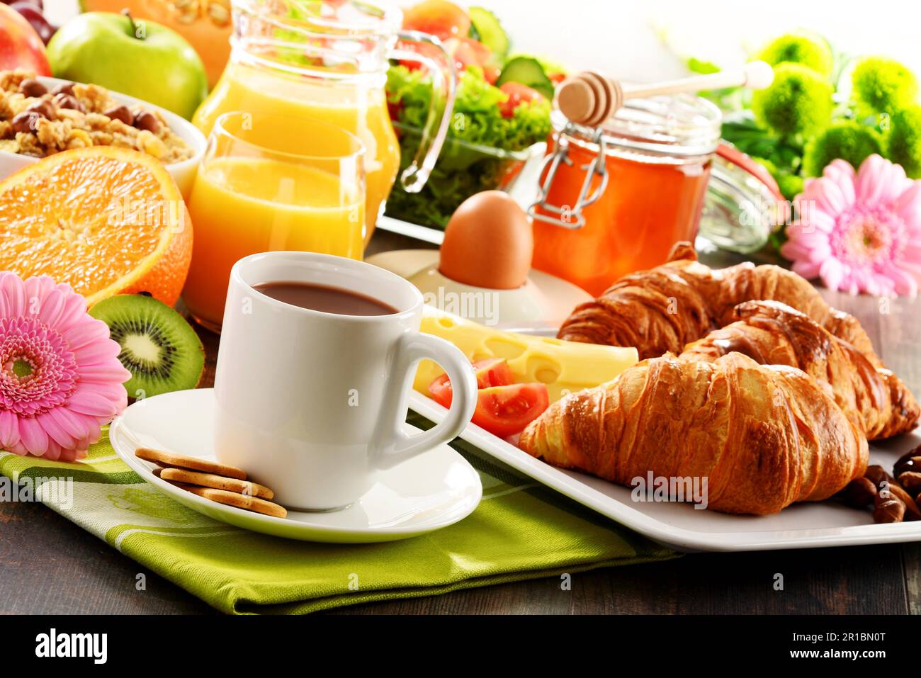 Breakfast consisting of fruits, orange juice, coffee, honey, bread and ...