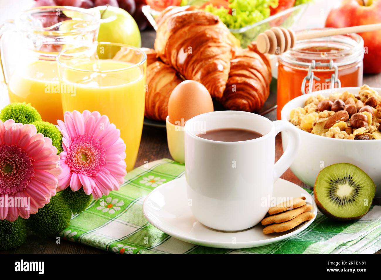 Breakfast consisting of fruits, orange juice, coffee, honey, bread and ...