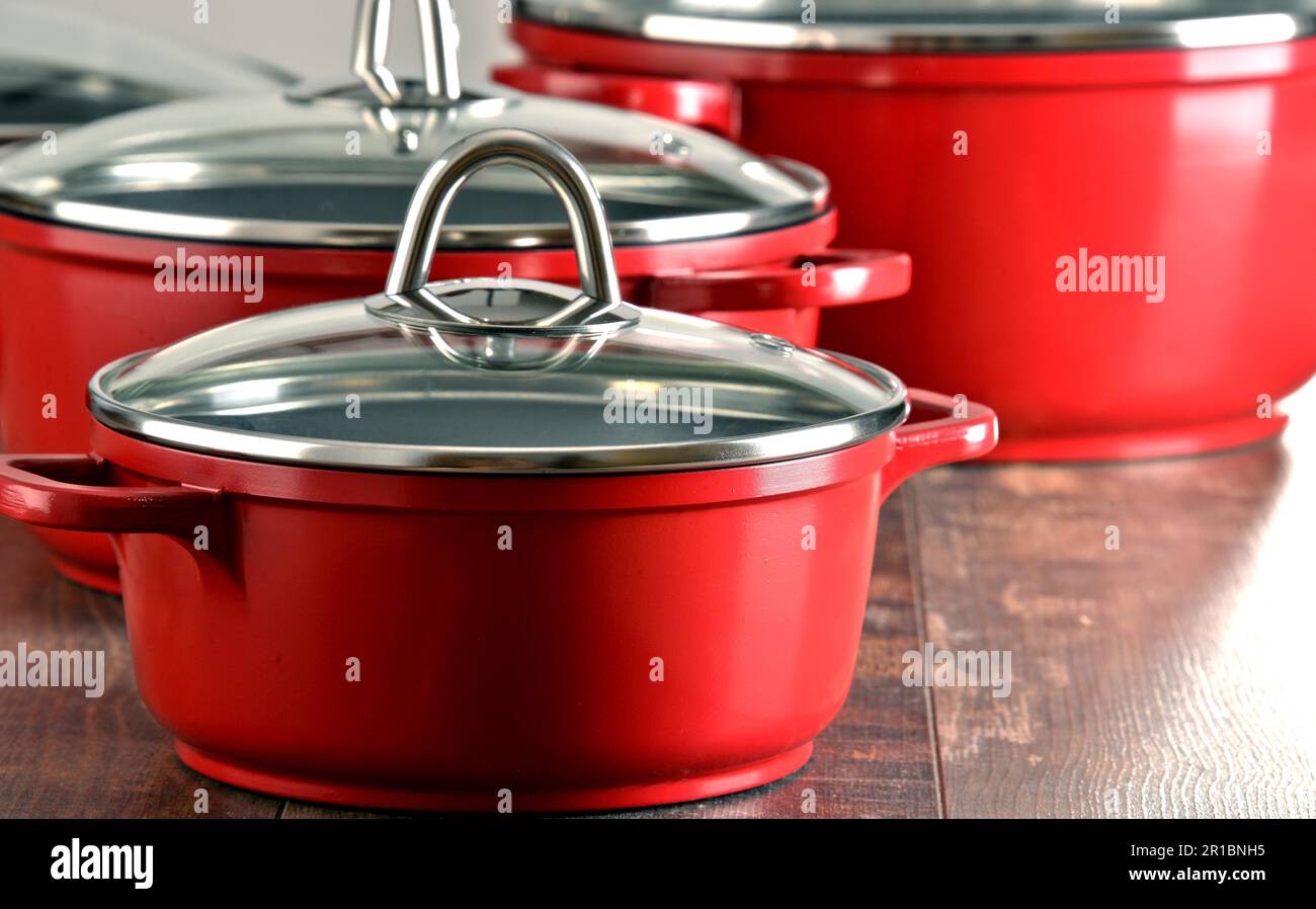 Composition with four steel kitchen pots Stock Photo - Alamy