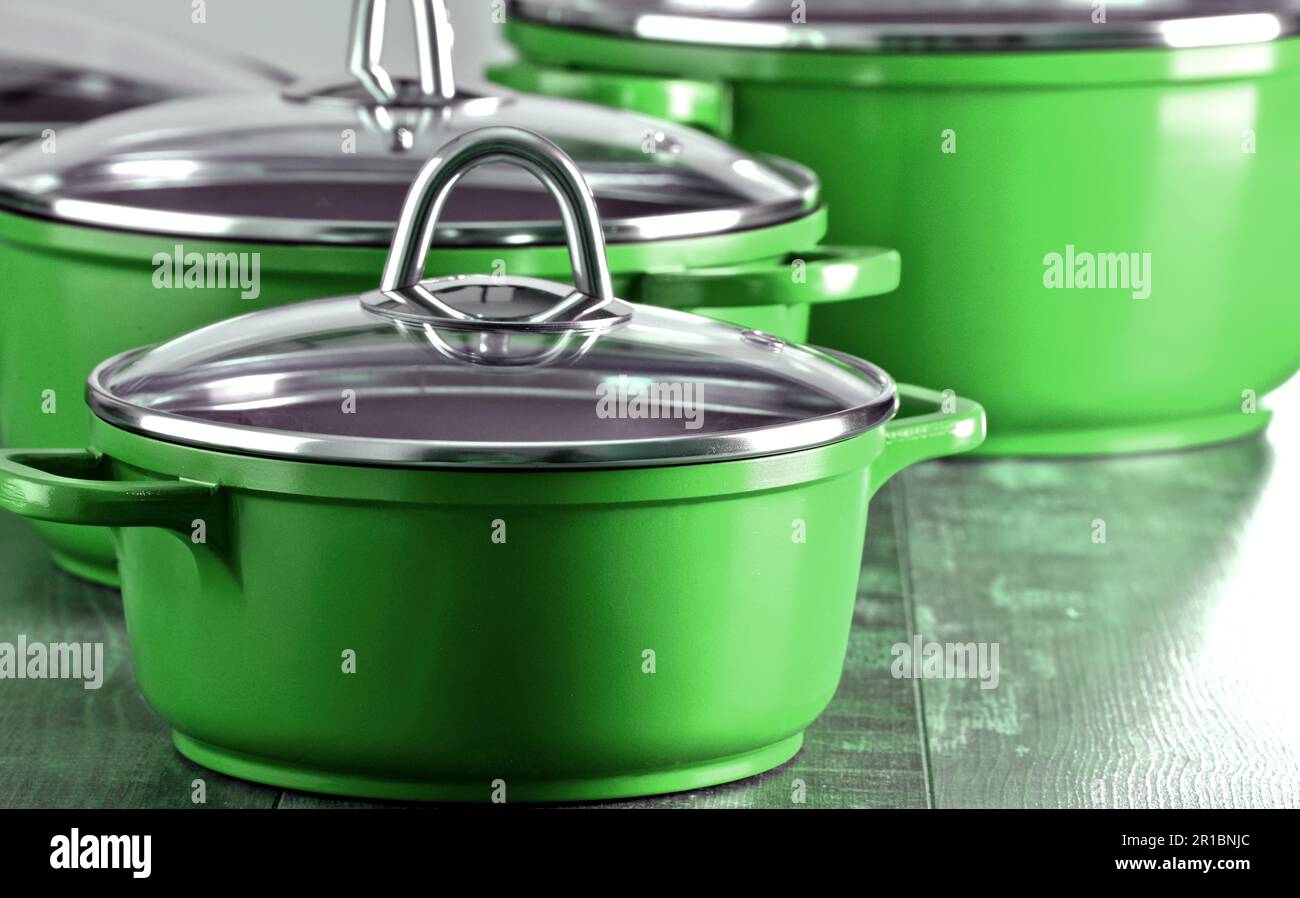 Composition with four steel kitchen pots Stock Photo - Alamy