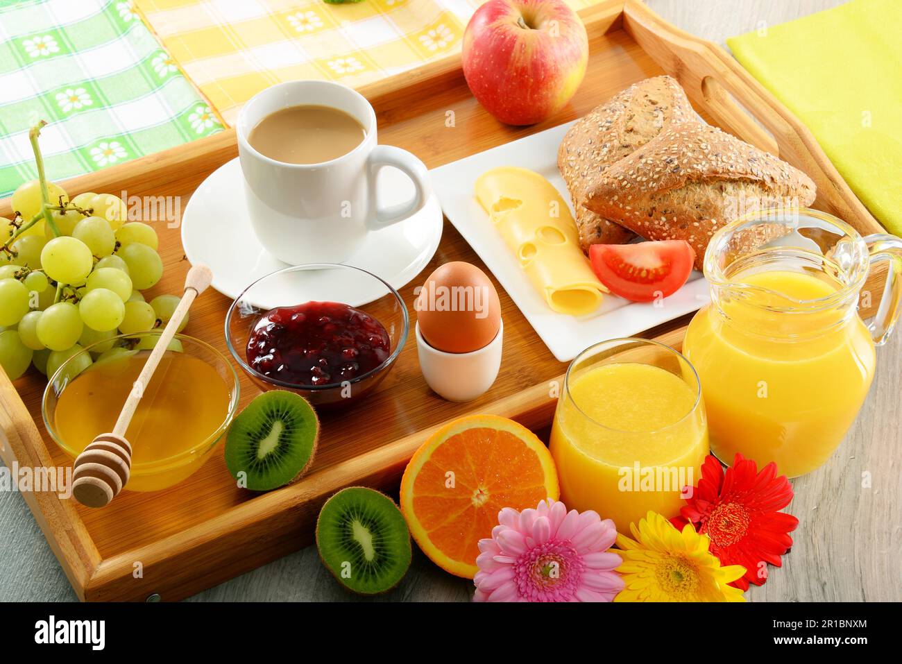 Breakfast on tray served with coffee, orange juice, egg, rolls and honey. Balanced diet Stock ...