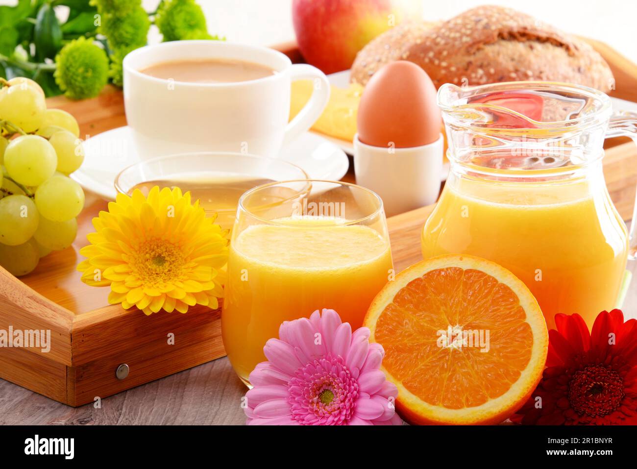 Breakfast on tray served with coffee, orange juice, egg, rolls and ...