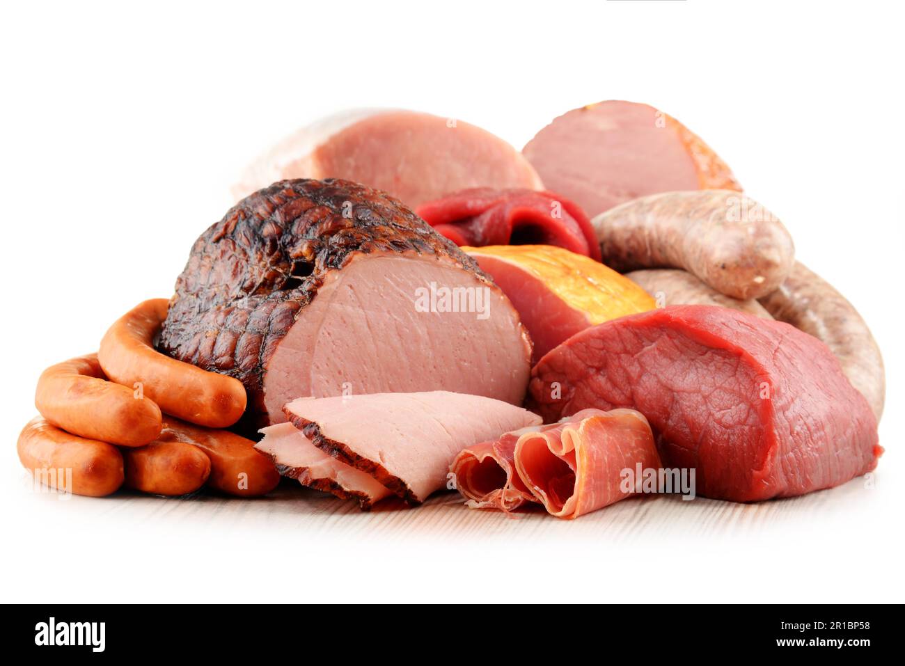 Assorted meat products including ham and sausages isolated on white ...
