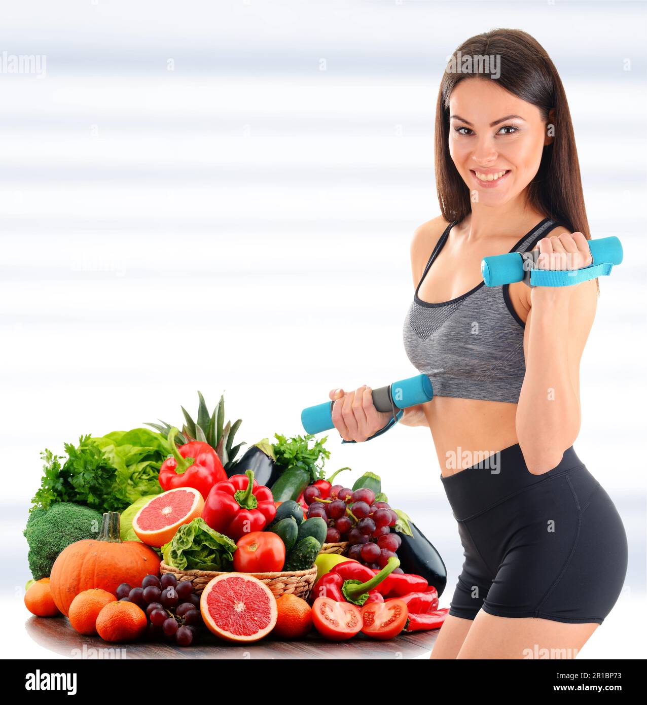 Young woman with variety of organic vegetables and fruits. Balanced ...