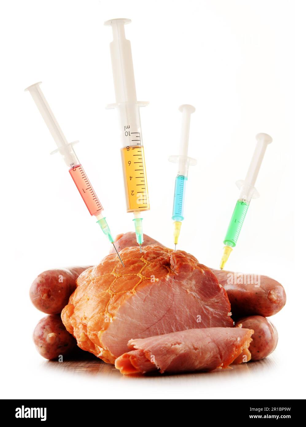 Syringes and meat isolated on white. Genetically modified food. GMO ...