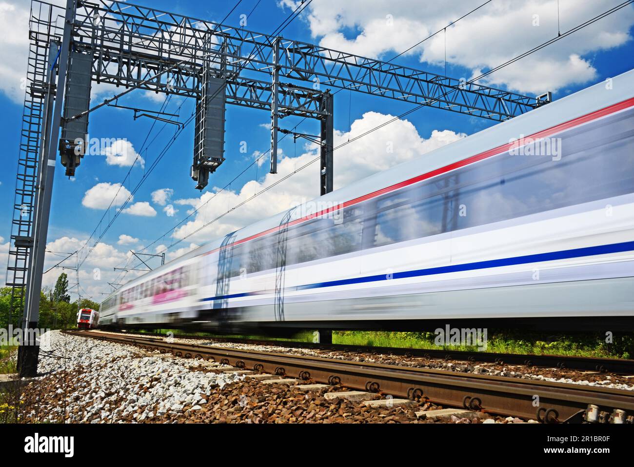 Modern electric passenger train moving on full speed Stock Photo - Alamy