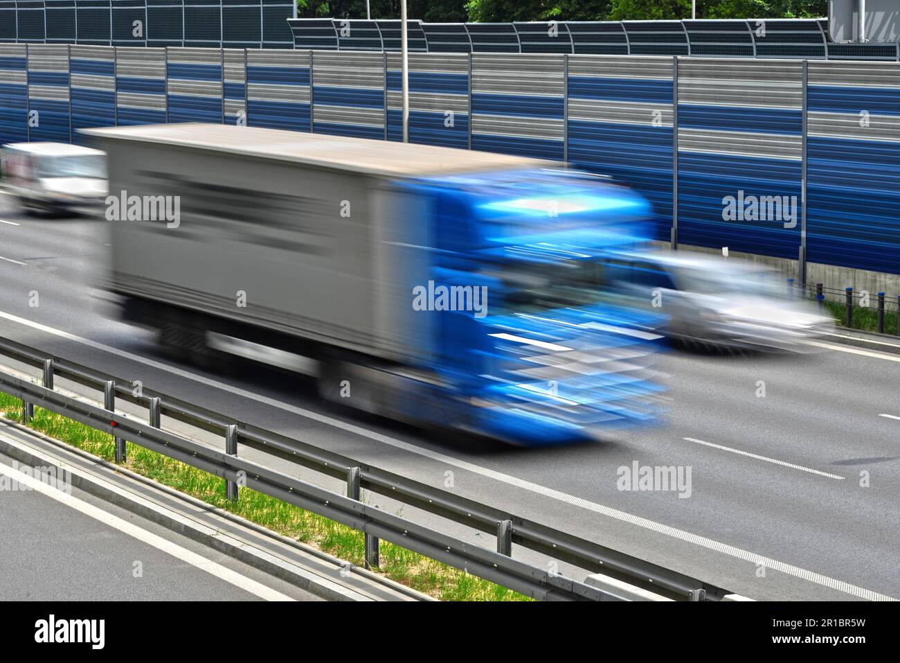 Large goods vehicle moving at full speed on six lane controlled-access ...