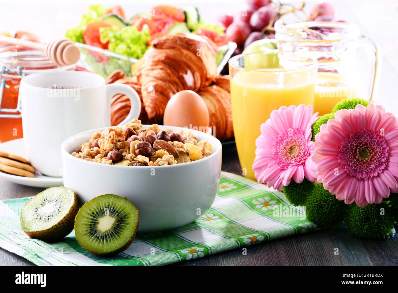 Breakfast consisting of fruits, orange juice, coffee, honey, bread and ...