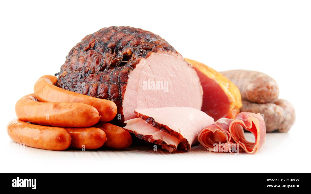 Assorted meat products including ham and sausages isolated on white ...