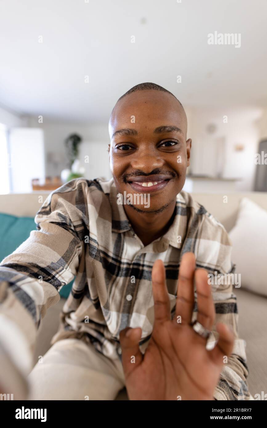 Smiling man waving hand hi-res stock photography and images - Alamy