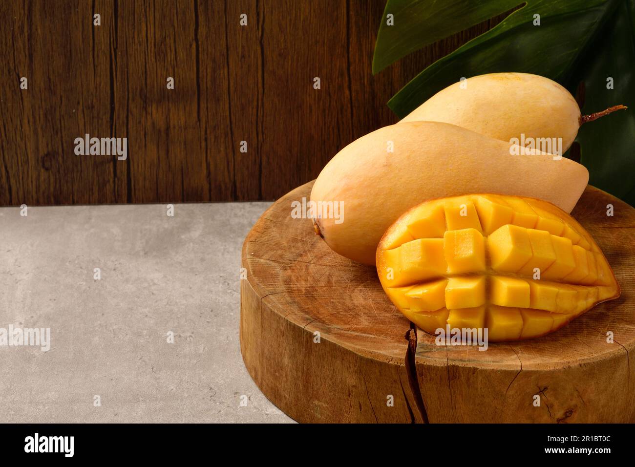 Yellow mango and mango slice cubes on wooden with wood background ...