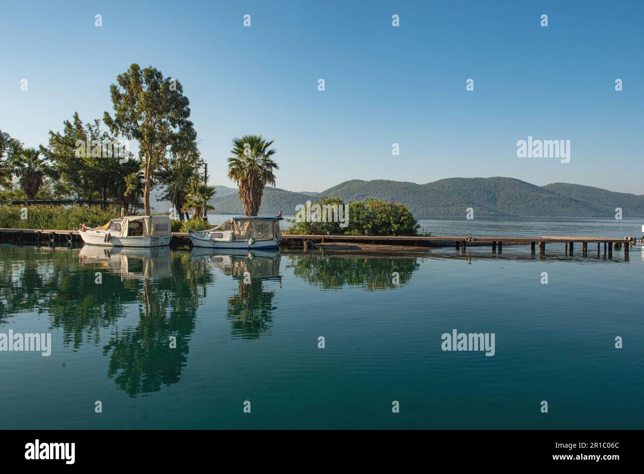 Boats are moored at the beautiful harbour of Turkish Riviera seaside ...