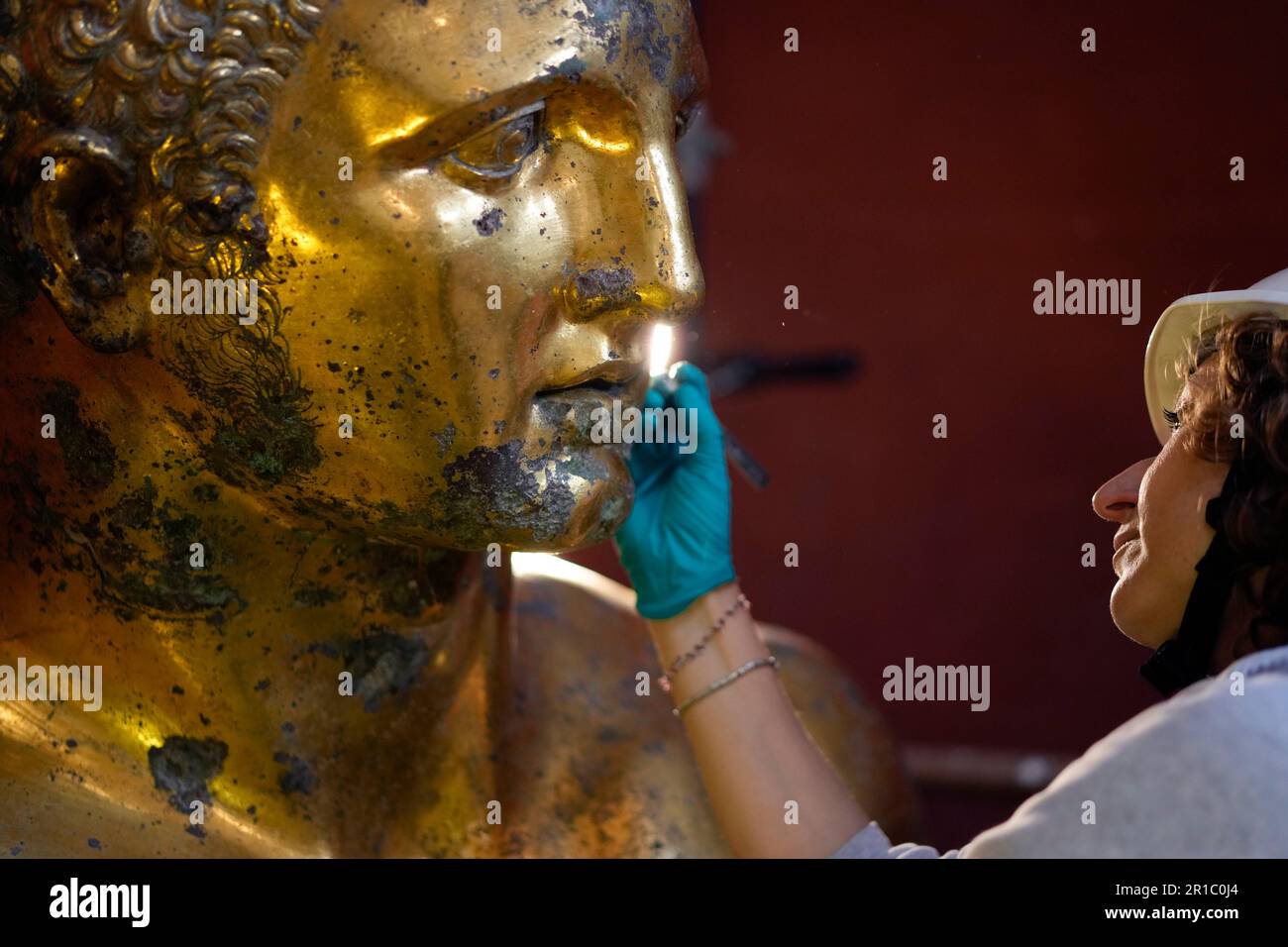Vatican Museum restorer Alice Baltera works on the bronze Hercules ...