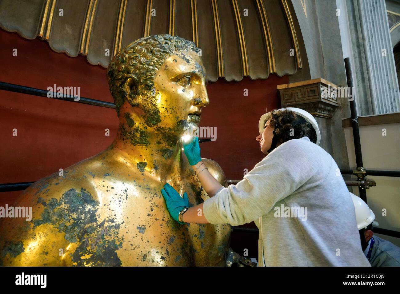 Vatican Museum restorer Alice Baltera works on the bronze Hercules ...