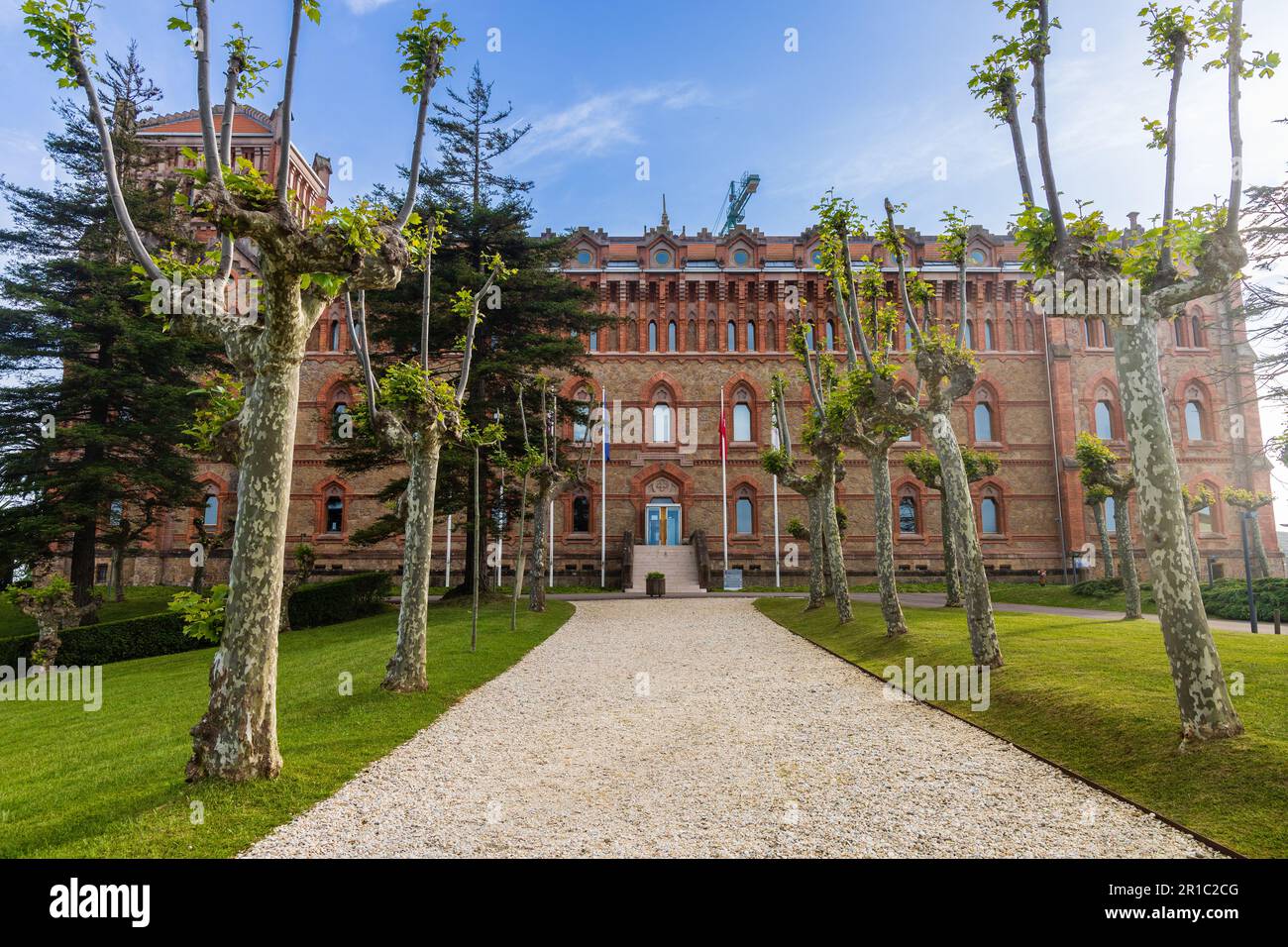 Park avenue with trees leading to the building of the Seminario Mayor ...