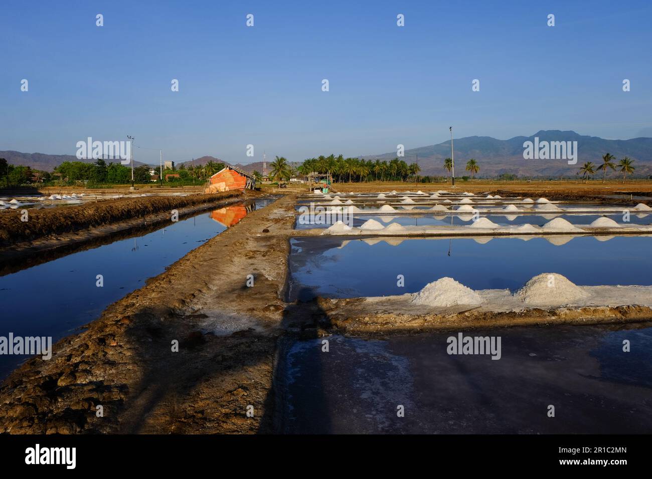 The process of crystallization of sea water into salt in the ...