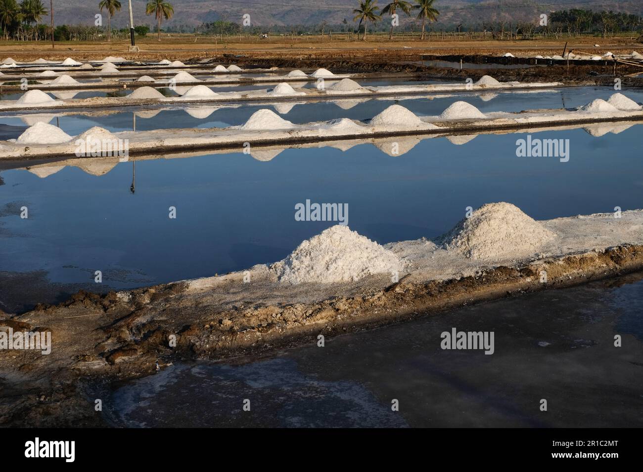 The process of crystallization of sea water into salt in the ...