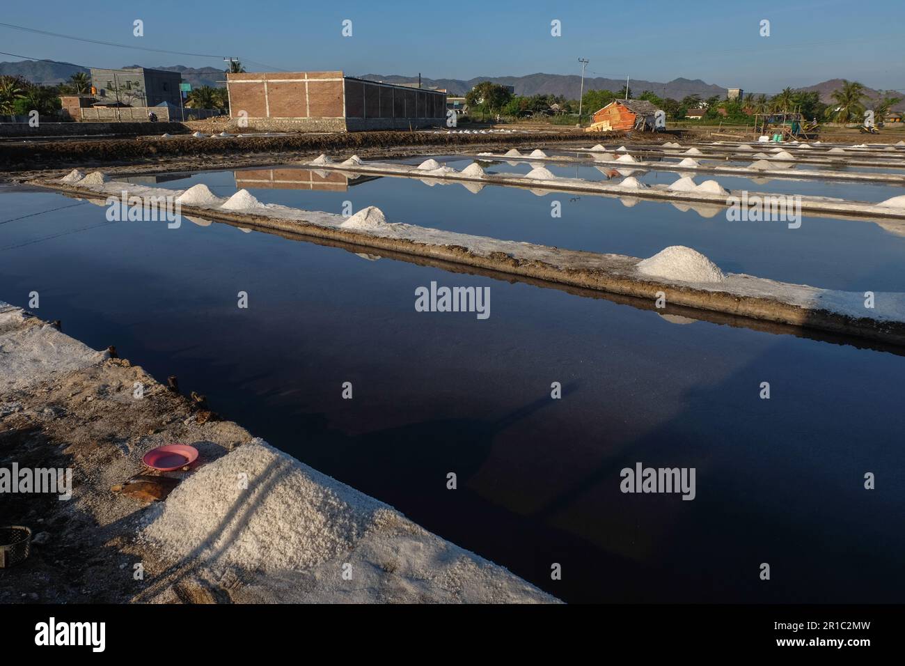 The process of crystallization of sea water into salt in the ...