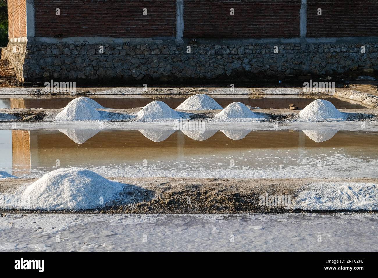The process of crystallization of sea water into salt in the ...