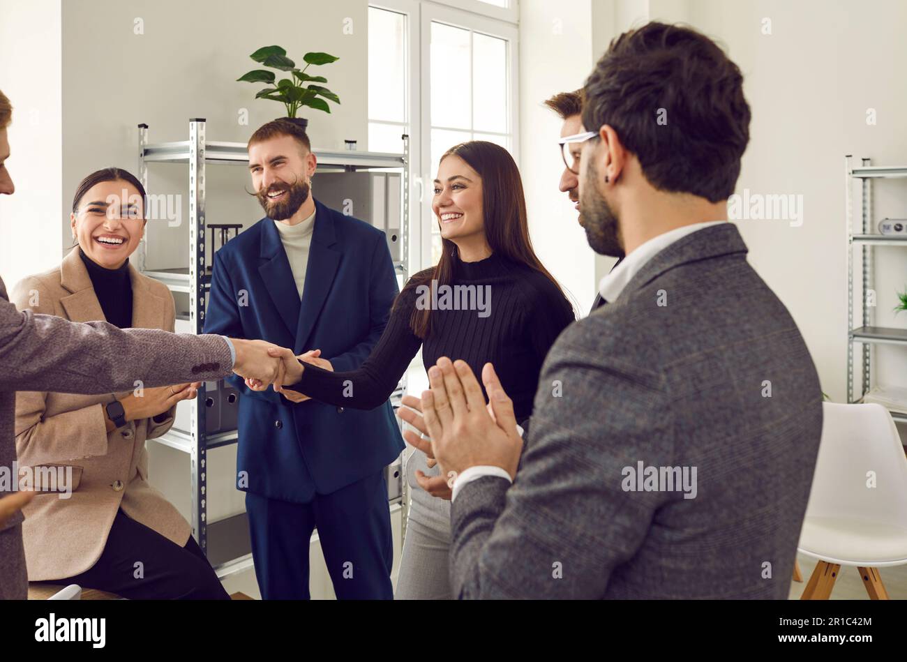 Team leader handshaking employee congratulating with professional ...