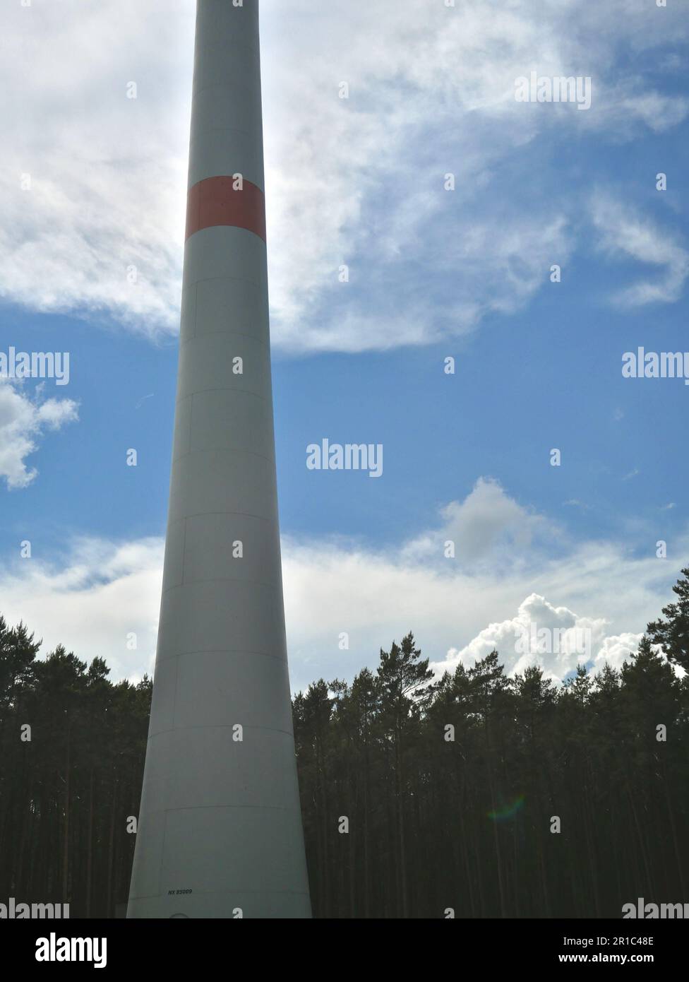 pole of a wind power plant in the forest Stock Photo - Alamy