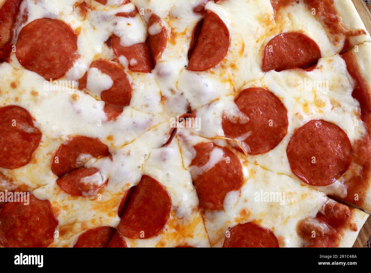 Part of pepperoni pizza in a restaurant Stock Photo - Alamy