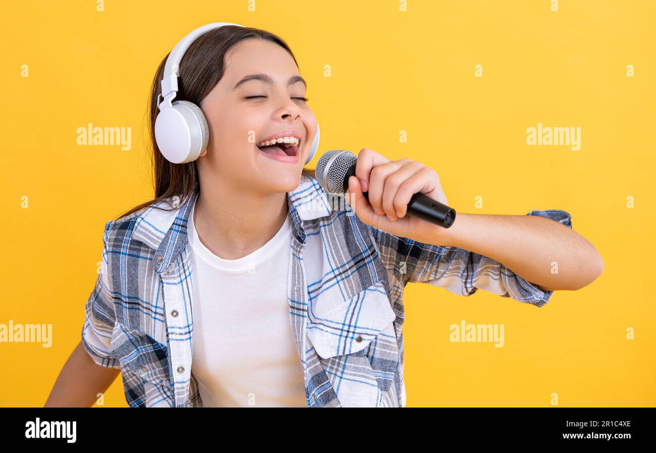 teen girl karaoke singer in headphones on background. photo of teen ...