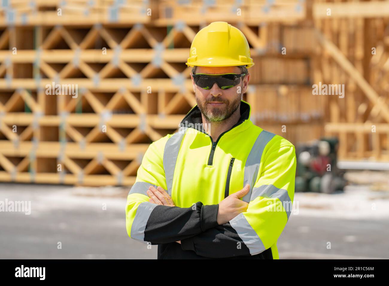 Worker in building uniform on buildings construction background ...