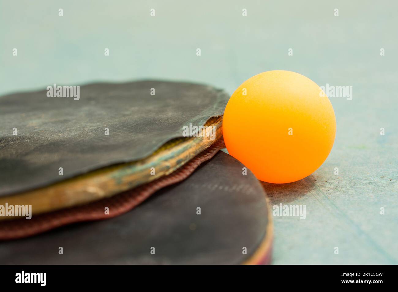 Ping pong paddles and ball on retro blue wooden background. Rackets ...