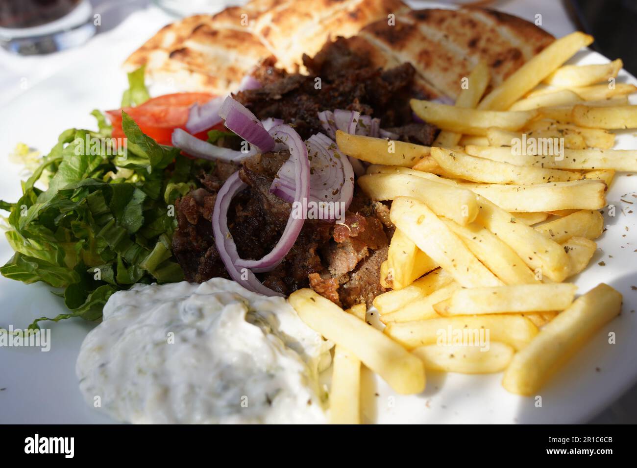 Traditional greek, turkish meat food on pita bread and tzatziki. Gyros ...