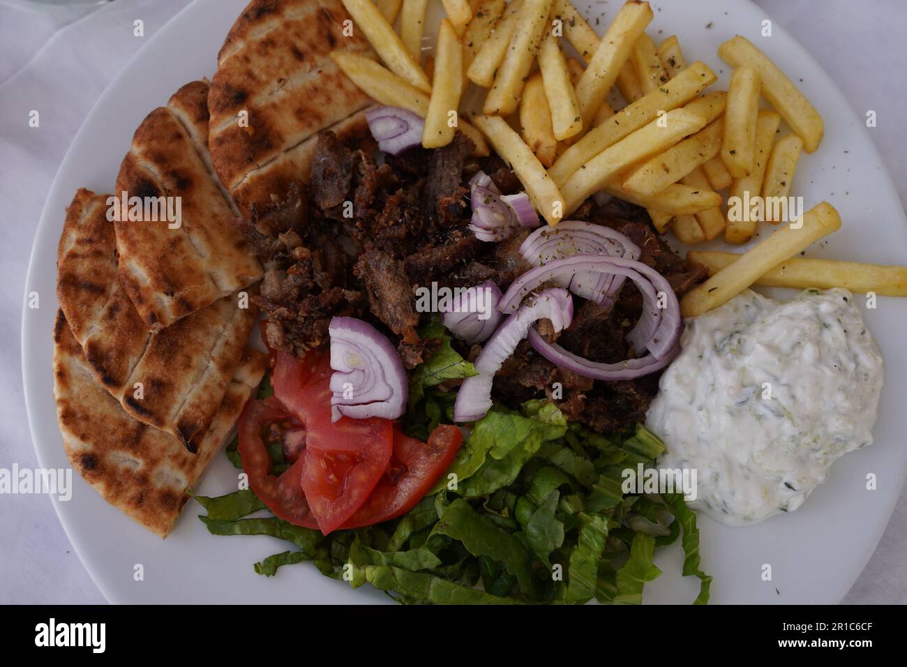 Traditional greek, turkish meat food on pita bread and tzatziki. Gyros ...