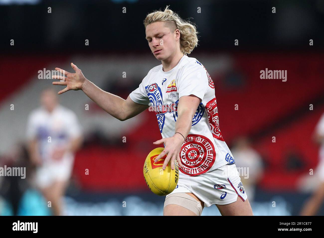 Cody Weightman of the Bulldogs kicks the ball during warm up prior to ...
