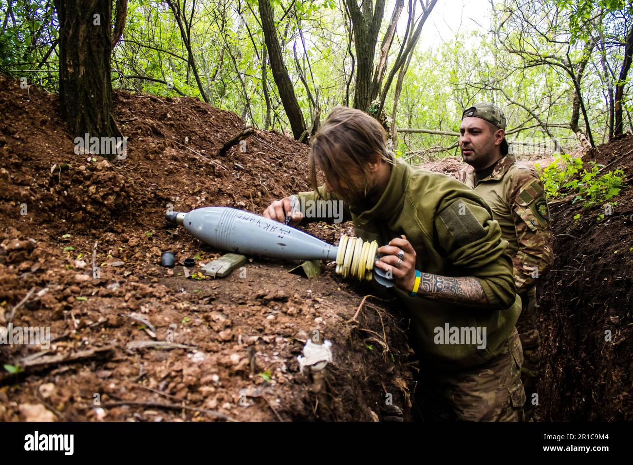 Ukrainian soldier from the 28th Artillery Battalion writing a message ...