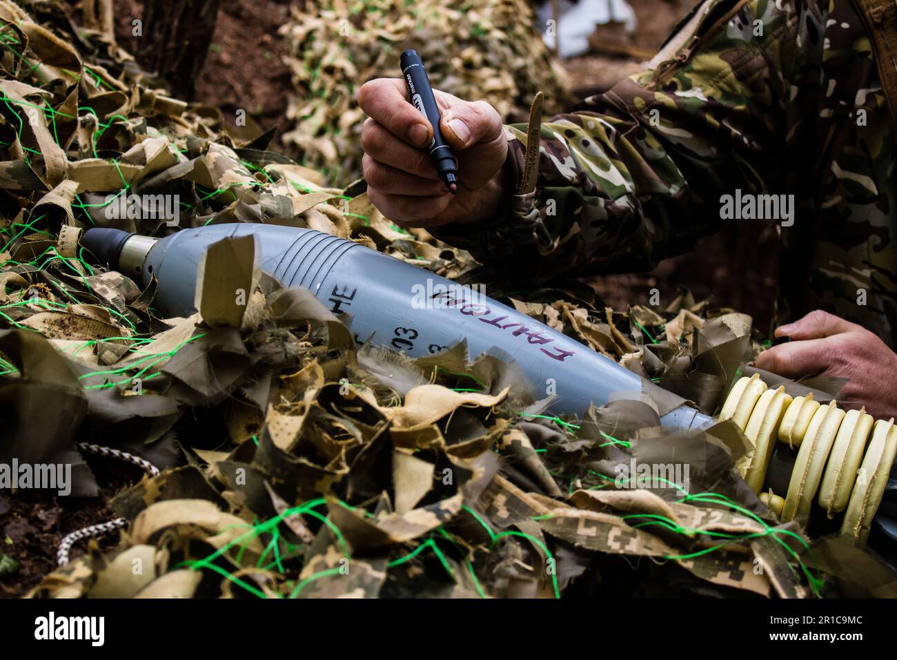 Ukrainian soldier from the 28th Artillery Battalion writing a message ...