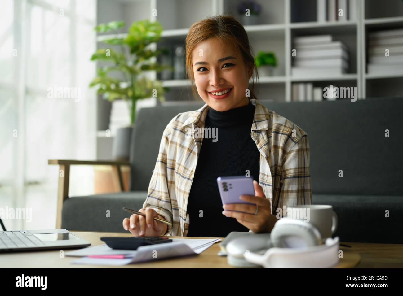 Beautiful young woman making payments online on e-banking application ...