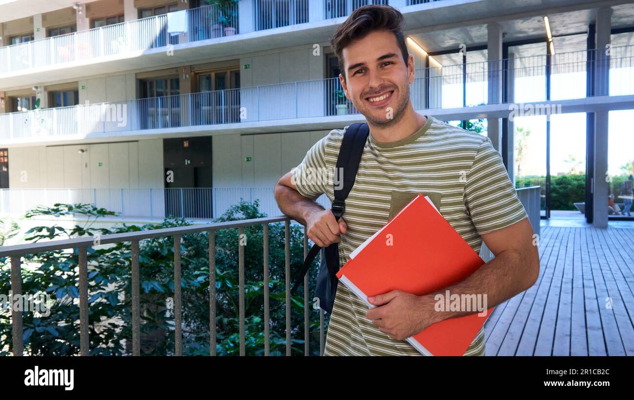 Portrait of caucasian male student at university campus looking at ...