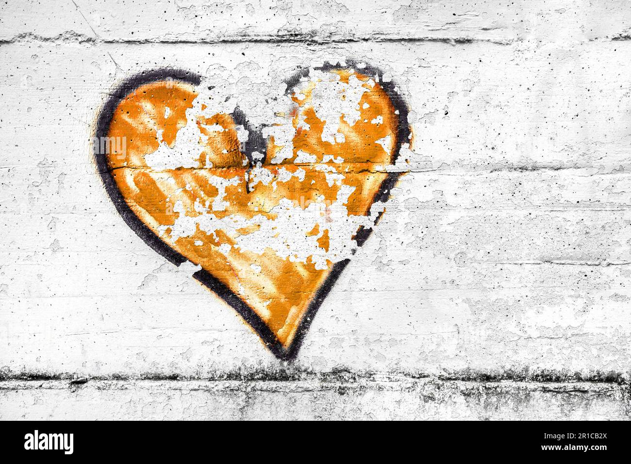 Painted orange abstract heart shape love symbol, dirty wall background ...