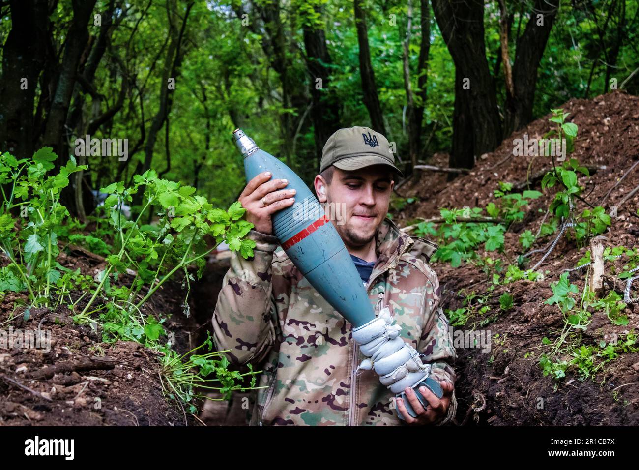 Ukrainian soldier from the 28th Artillery Battalion carrying a shell of ...